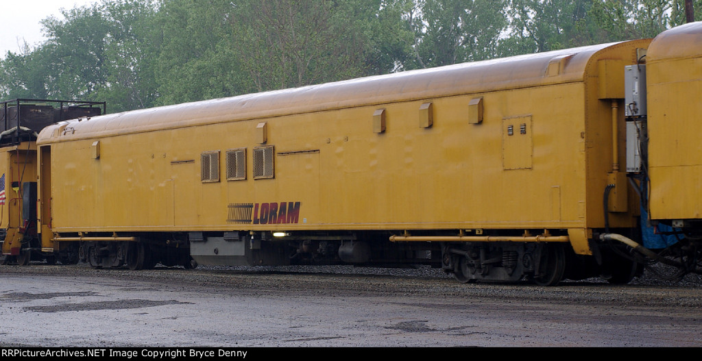 I'm not sure what this car is for, but it is part of the LORAM rail grinding train
